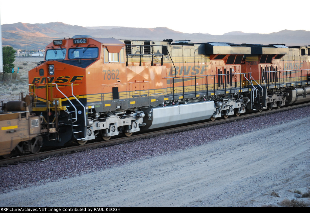 BNSF 7862 rolls eastbound into the rising sun behind BNSF 7495.